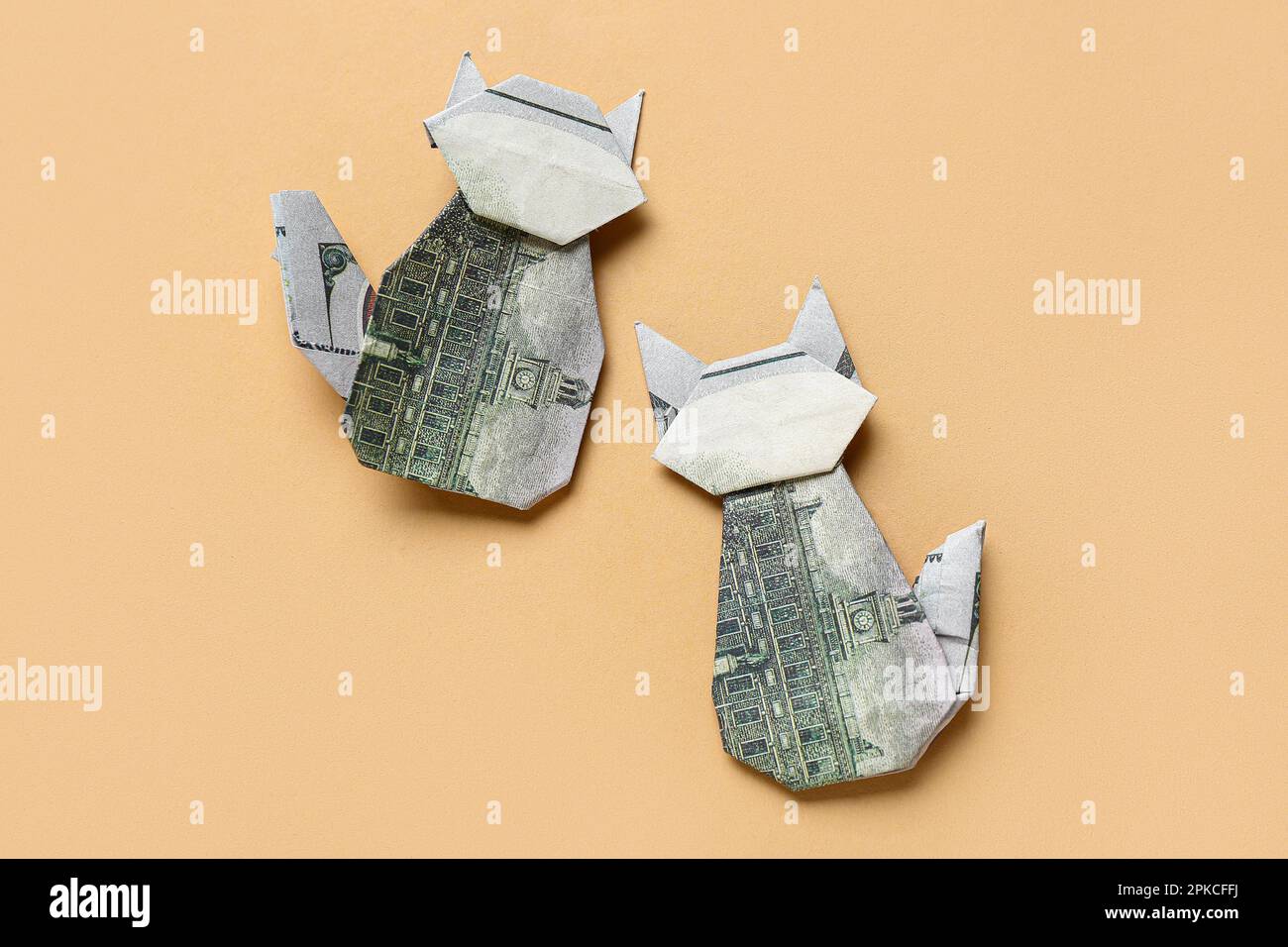 Origami cats made of dollar banknotes on beige background Stock Photo ...