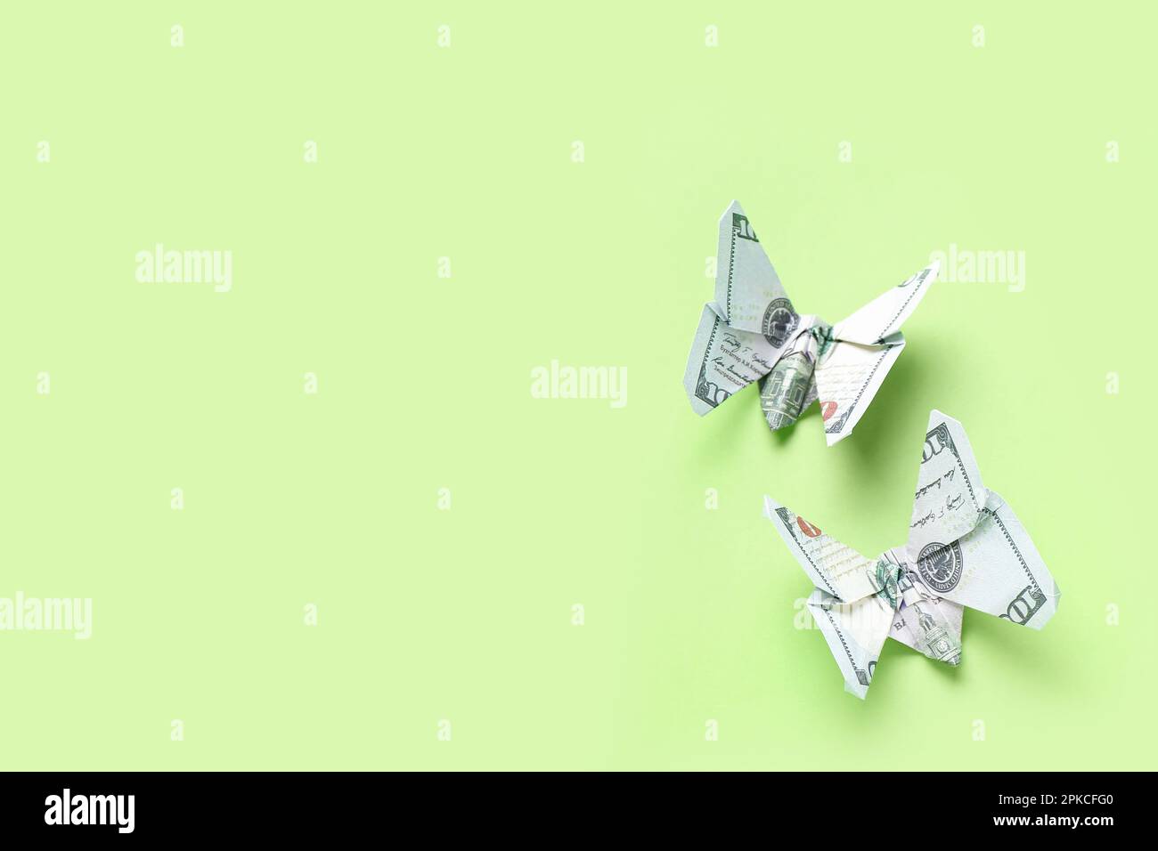 Origami butterflies made of dollar banknotes on green background Stock ...