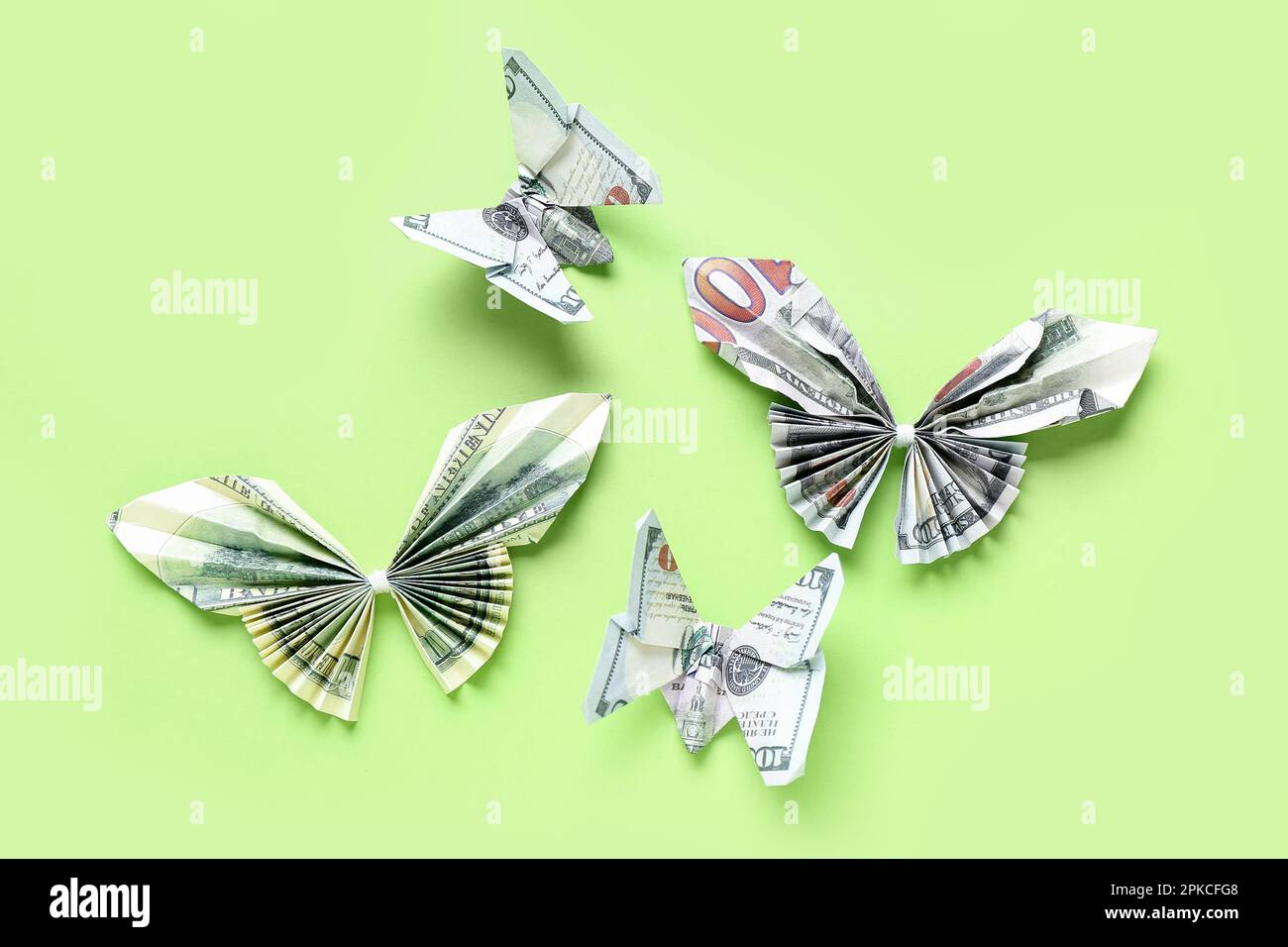Origami butterflies made of dollar banknotes on green background Stock ...