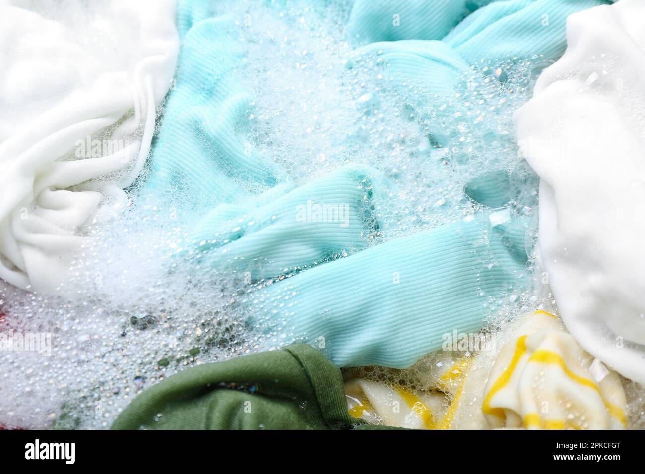Wet clothes with laundry detergent, closeup Stock Photo - Alamy
