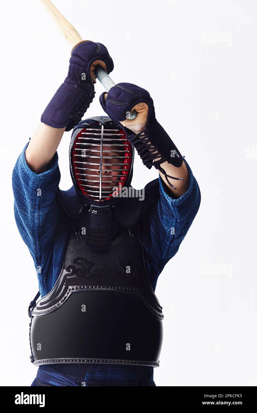A man wearing a kendo gi wielding a shinai Stock Photo - Alamy