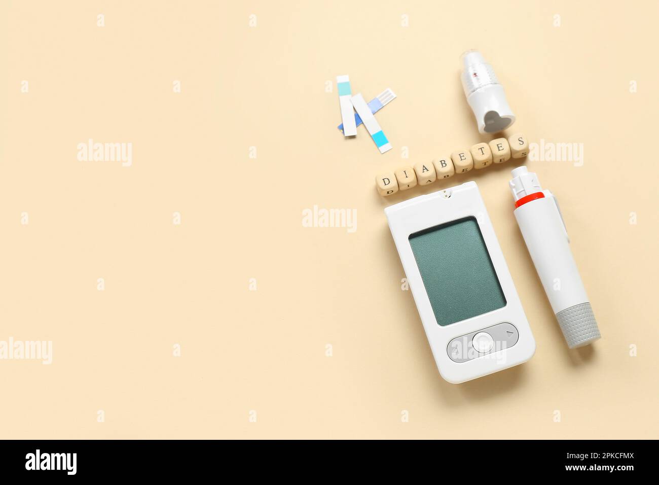 Word DIABETES with glucometer and lancet pen on beige background Stock ...