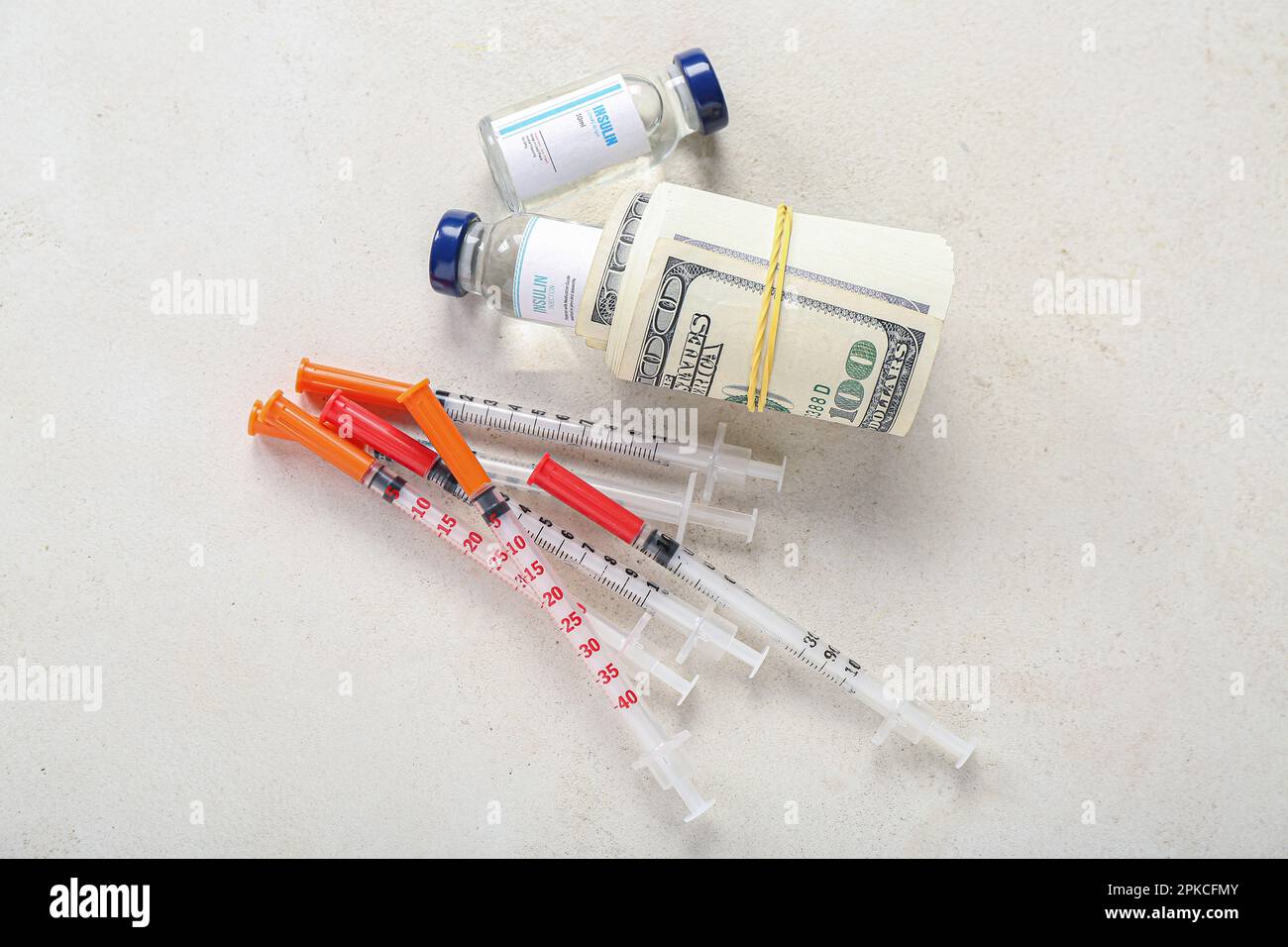 Insulin with syringes and money on white background. Expensive medicine ...