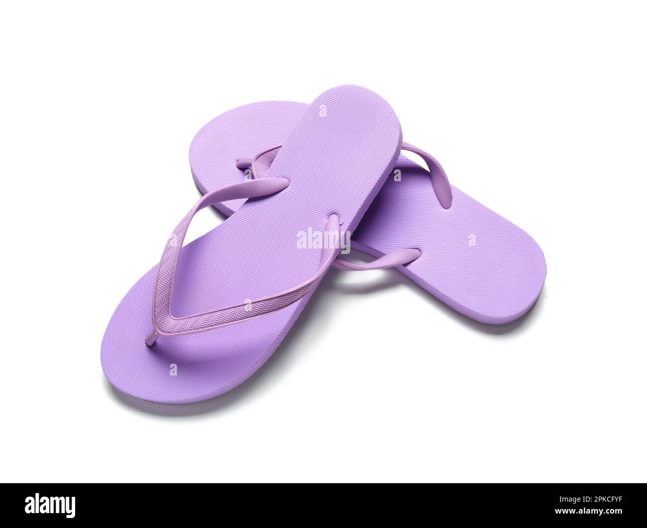 Pair of lilac flip-flops on white background Stock Photo - Alamy