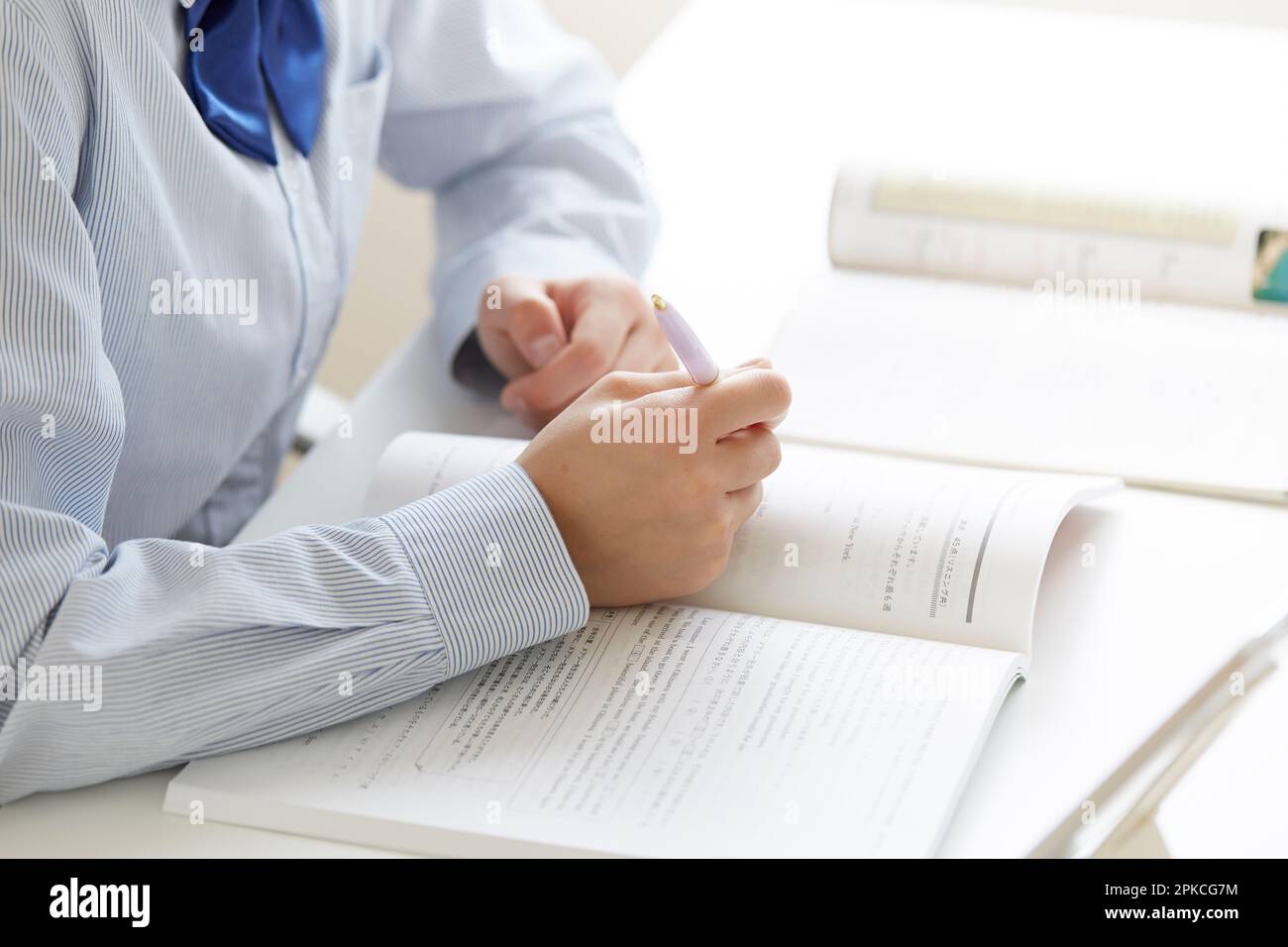 High school girl studying at a white desk Stock Photo - Alamy