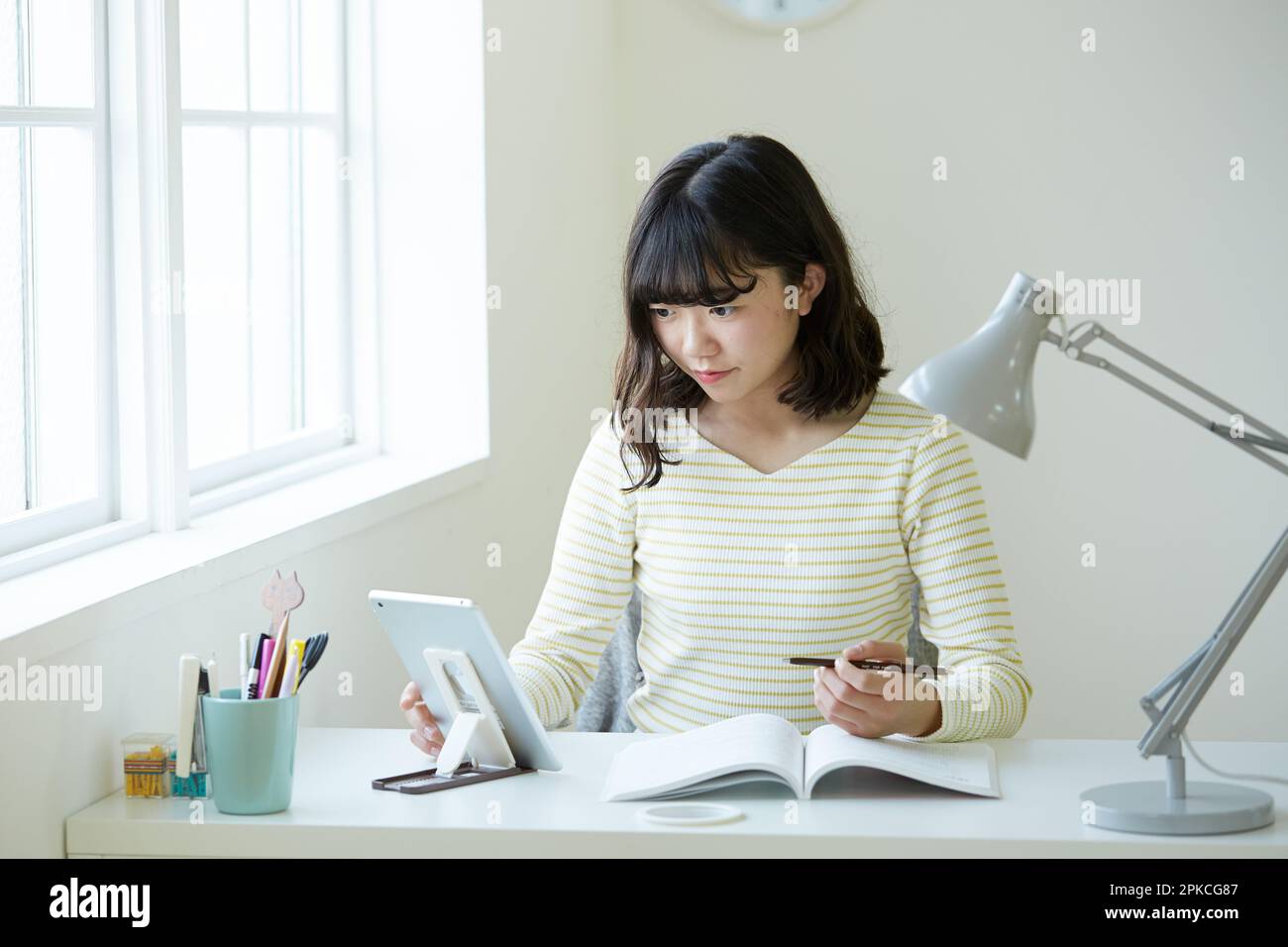 High school girl studying using a tablet PC Stock Photo - Alamy