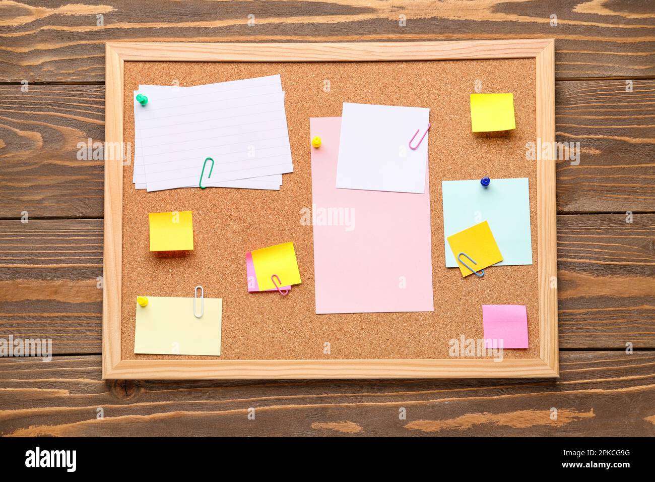 Board with different sticky notes on wooden background Stock Photo - Alamy