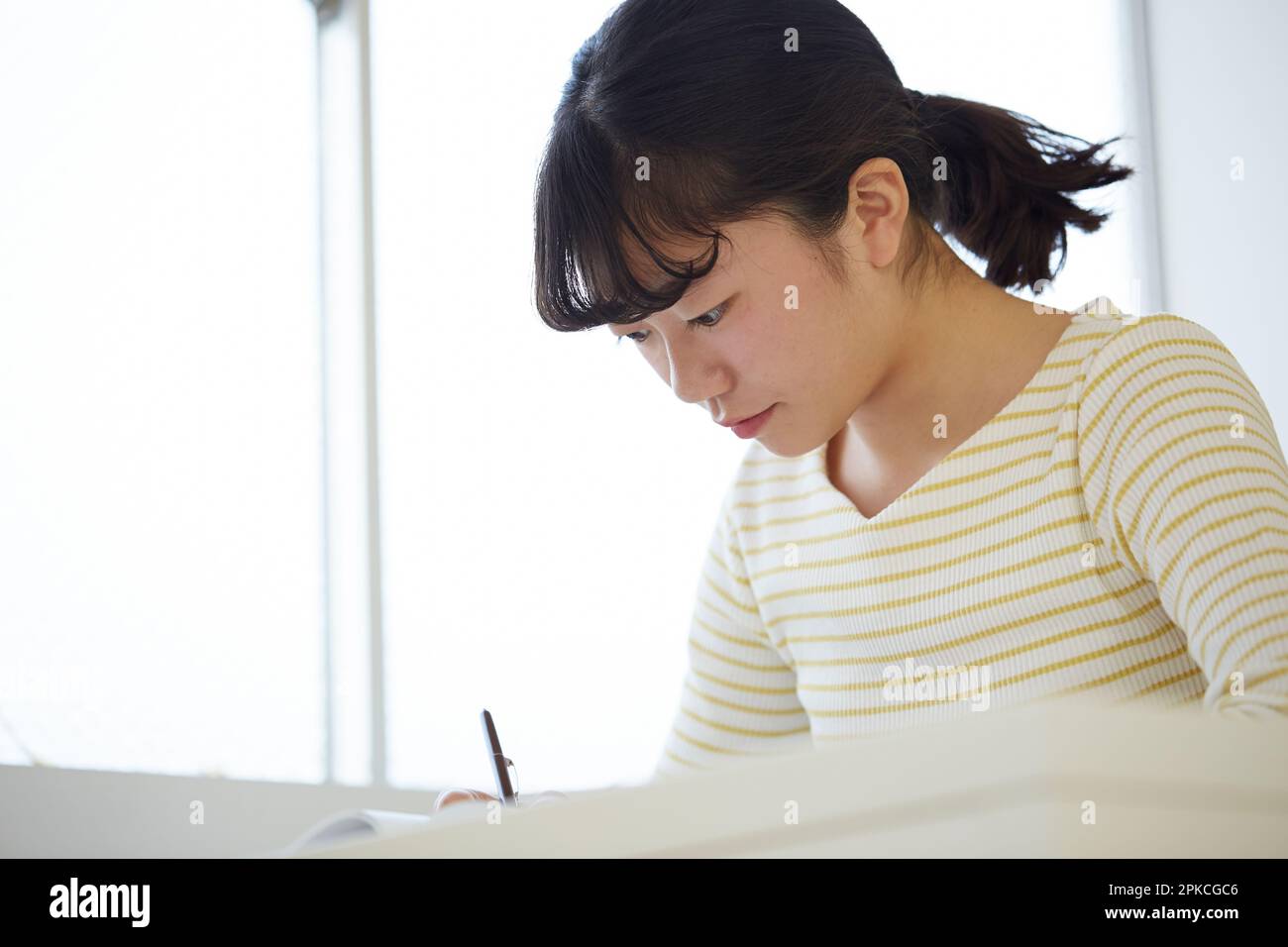 Woman seriously studying Stock Photo - Alamy
