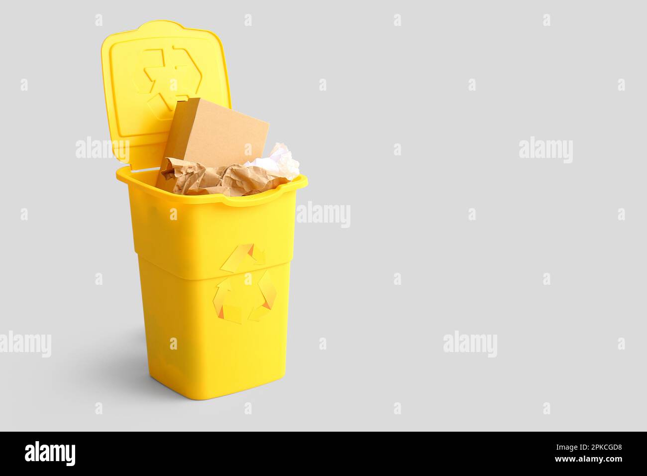 Container for garbage with paper on light background. Recycling concept ...
