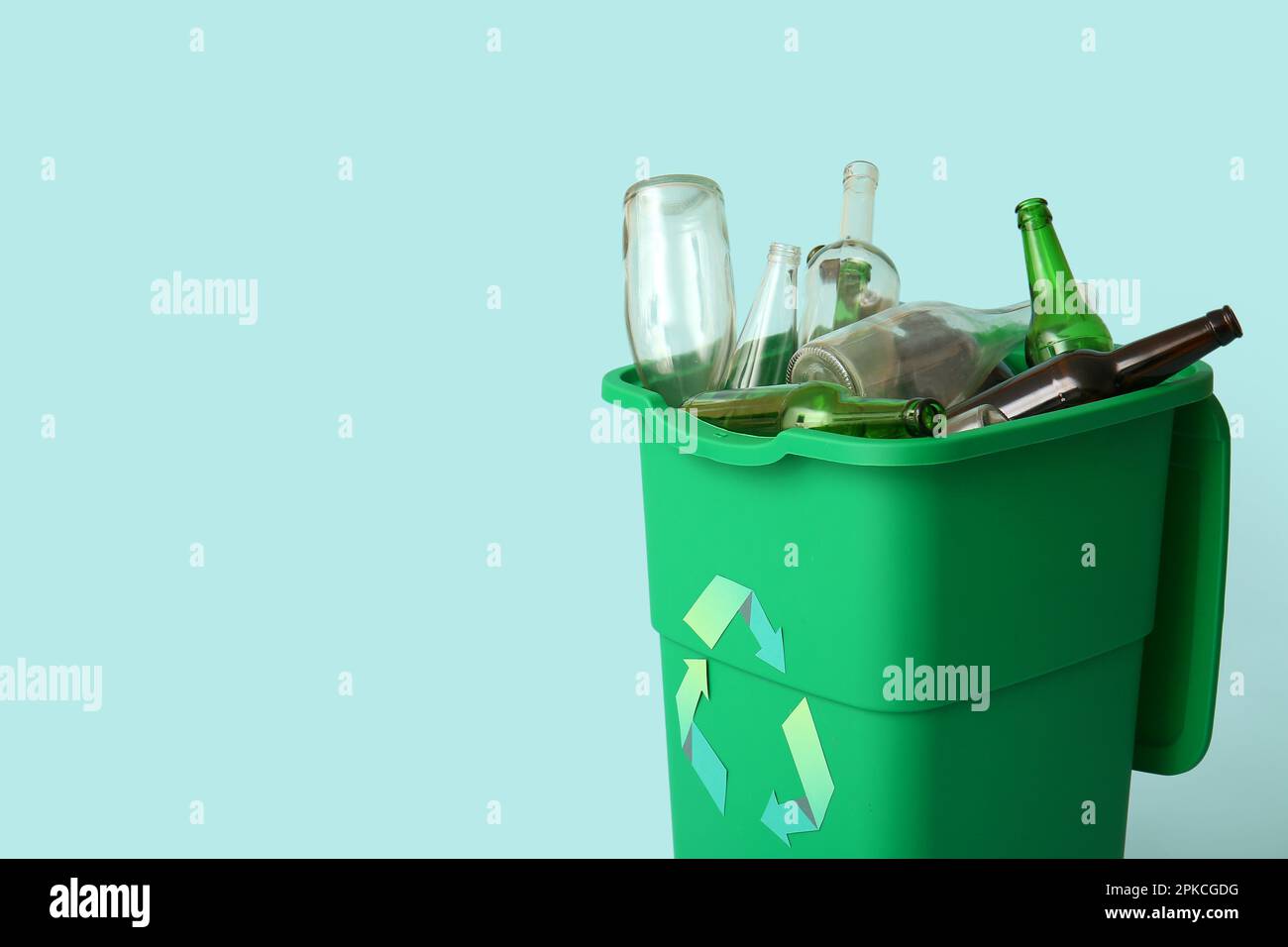 Container for garbage with glass bottles on light blue background ...