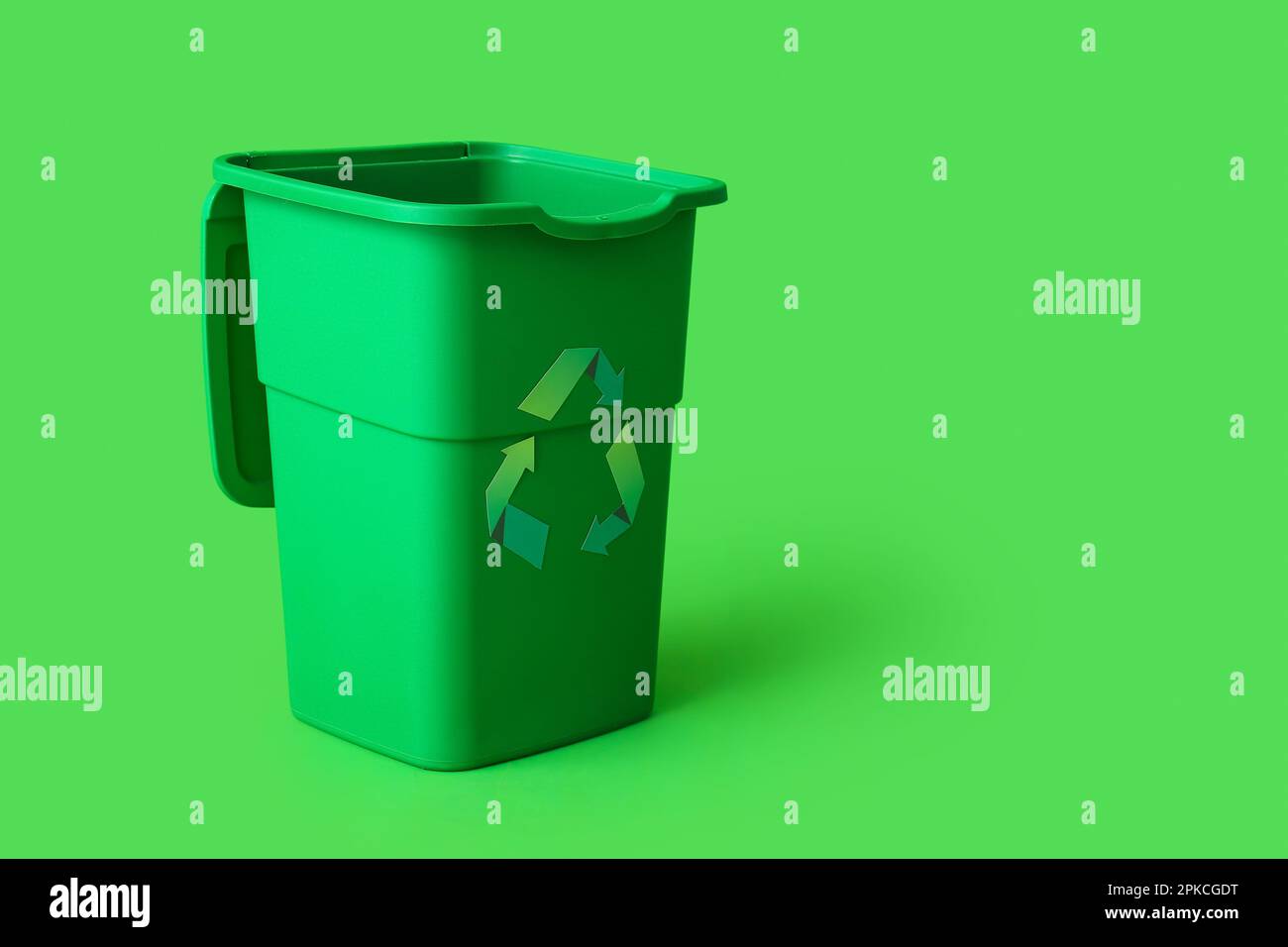 Container for garbage on green background. Recycling concept Stock ...