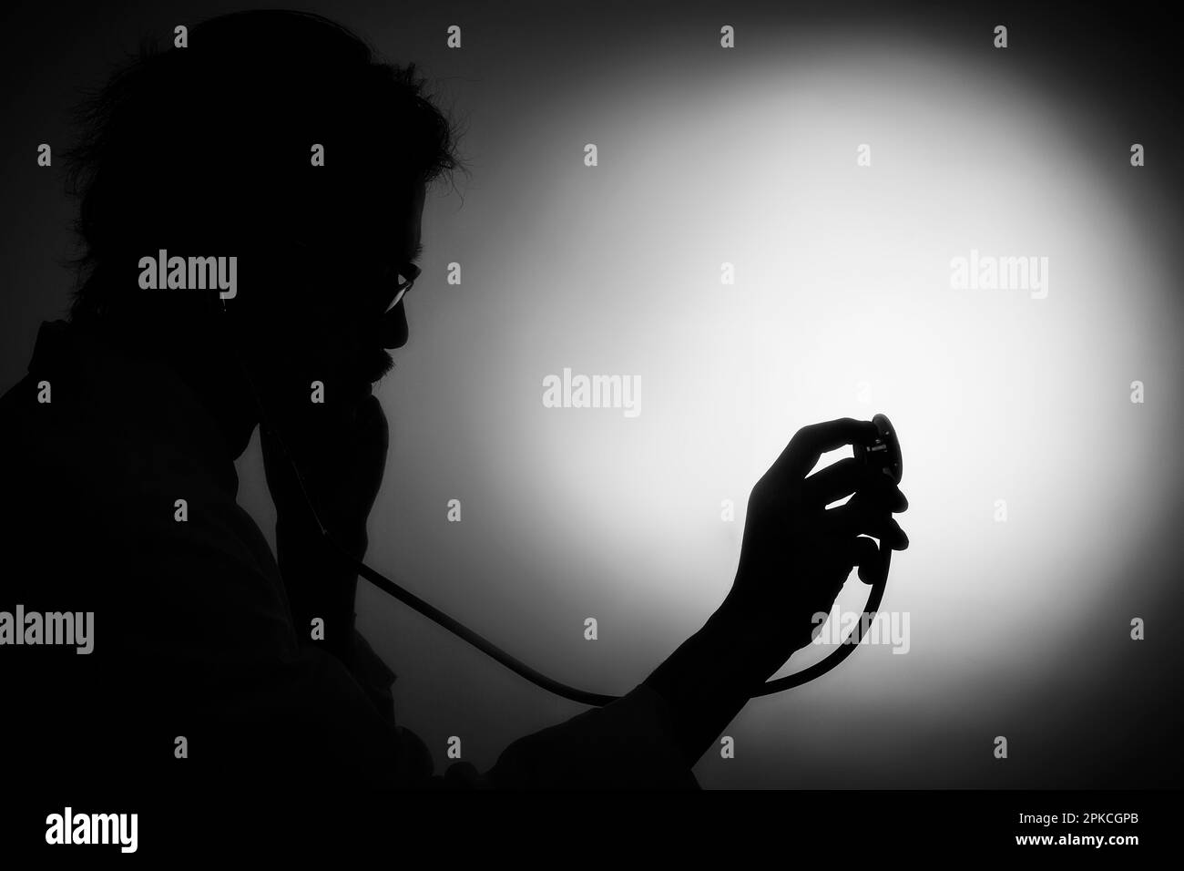 Shadow of male doctor applying stethoscope Stock Photo - Alamy