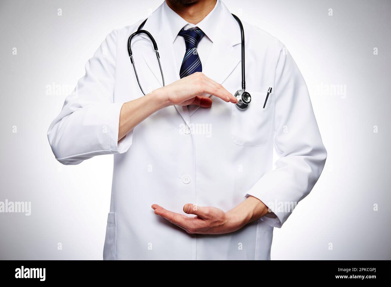Male doctor making a circle with his hand on his chest Stock Photo - Alamy