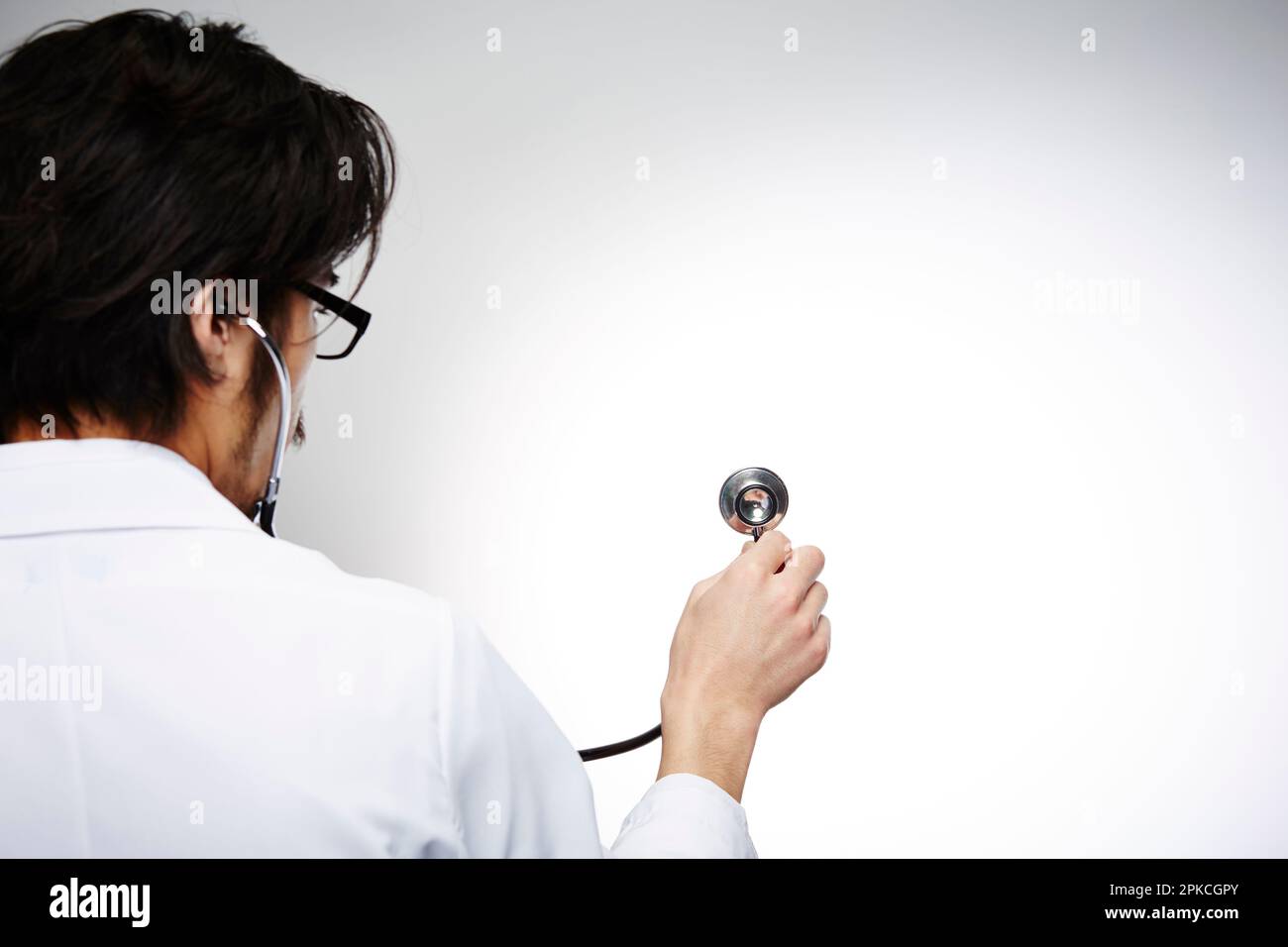 Back view of male doctor applying stethoscope Stock Photo - Alamy
