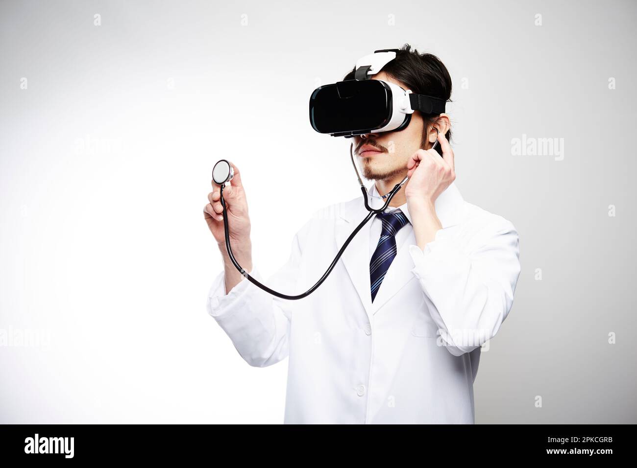 Male doctor wearing VR goggles and holding stethoscope Stock Photo - Alamy