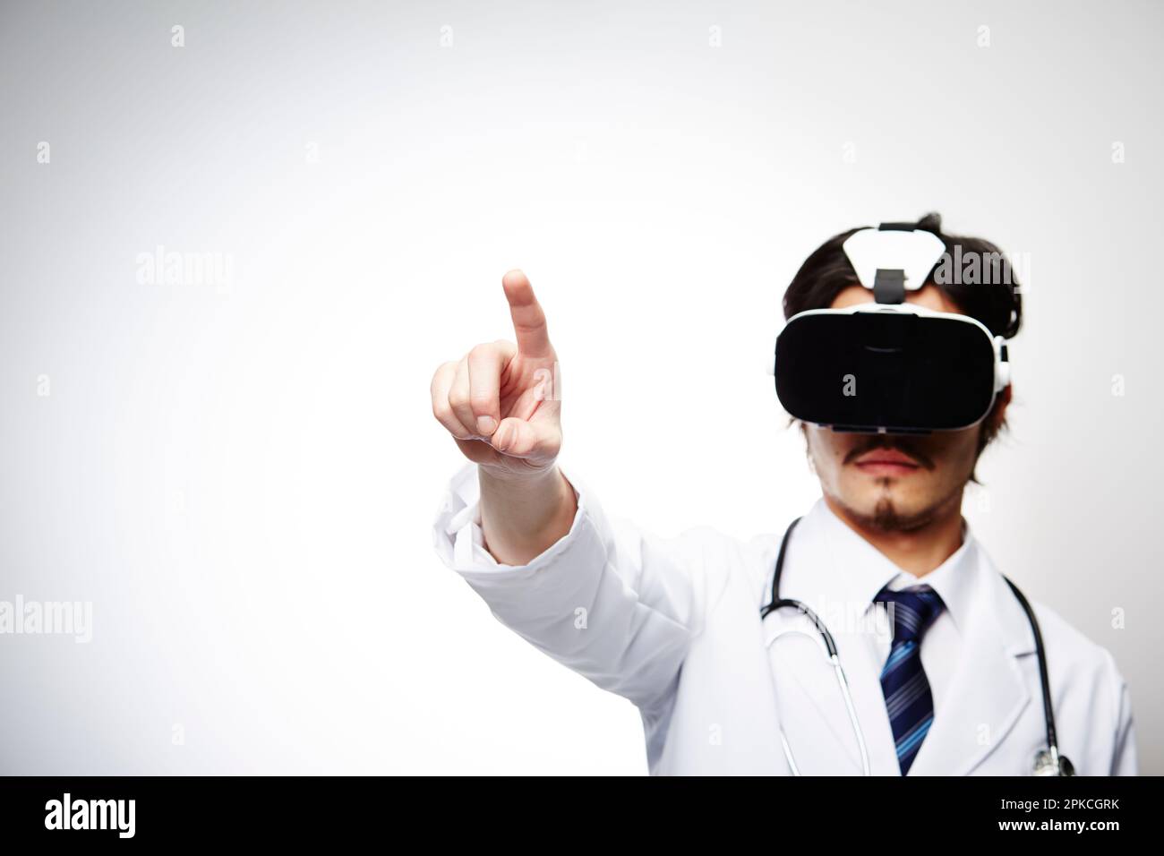 Male doctor wearing VR goggles and pointing Stock Photo - Alamy