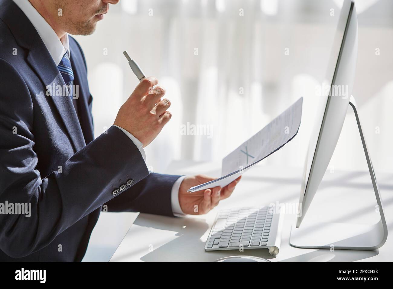 A businessman smoking an Icos while looking at documents Stock Photo ...