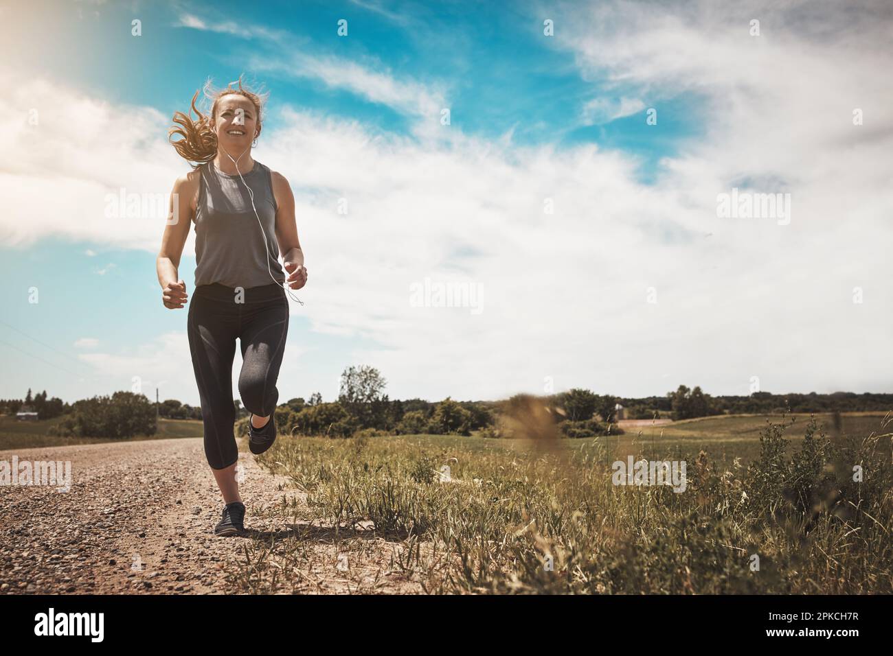 The best runs are those with scenic views. a young woman out on a trail ...