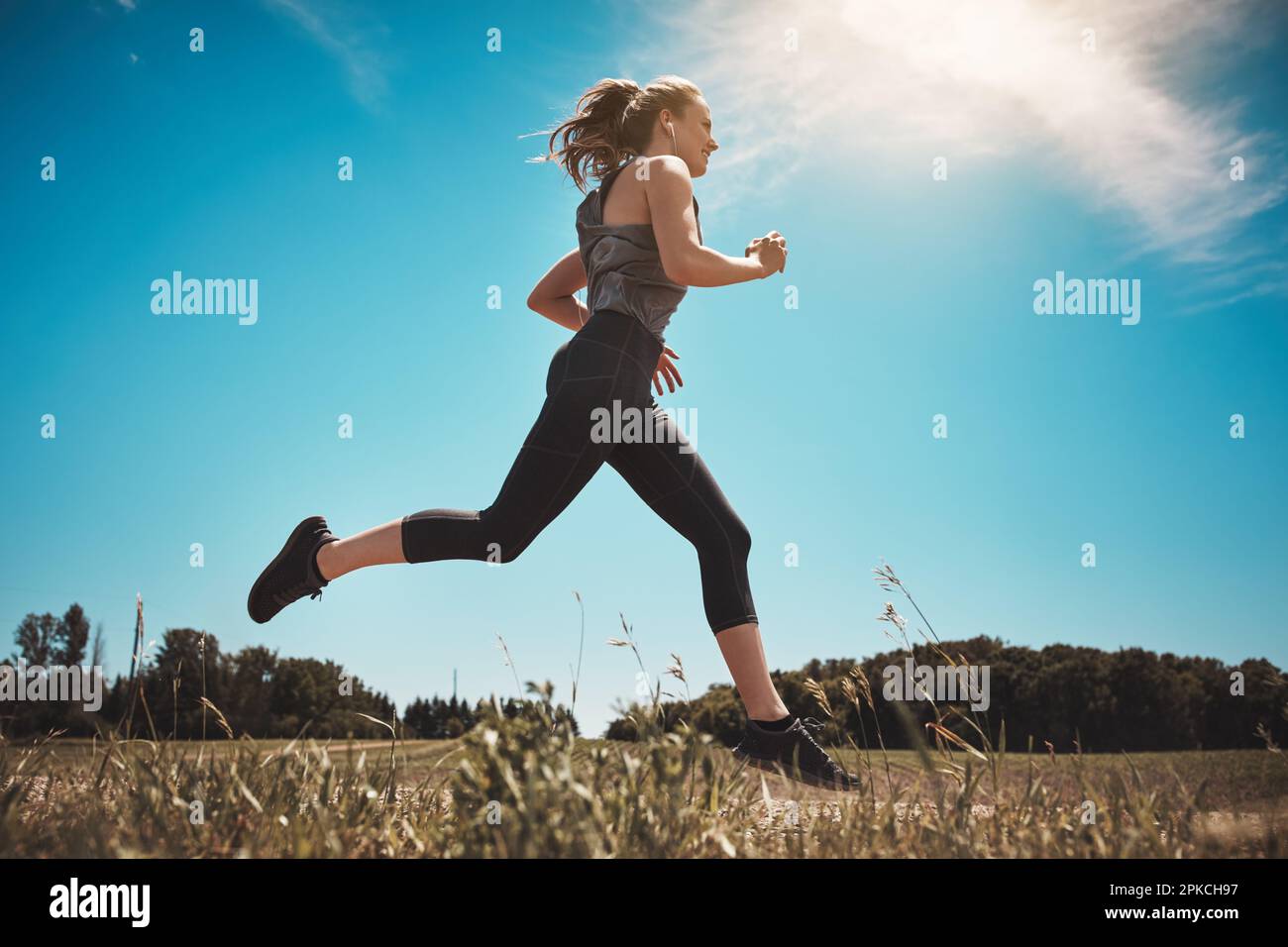 Leap straight over any obstacles in your way. a young woman out on a ...