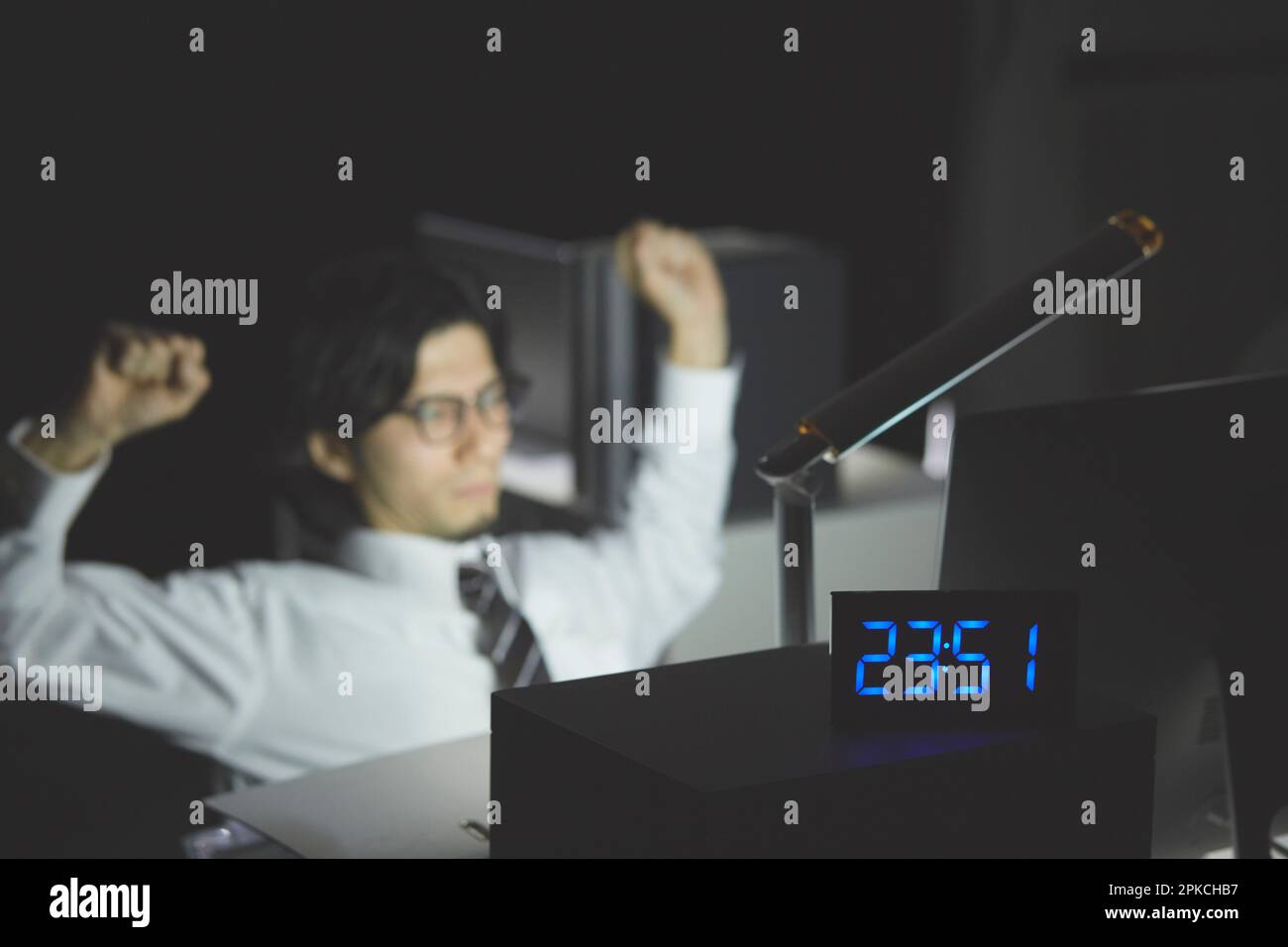 Man tired from working overtime until nearly midnight Stock Photo - Alamy