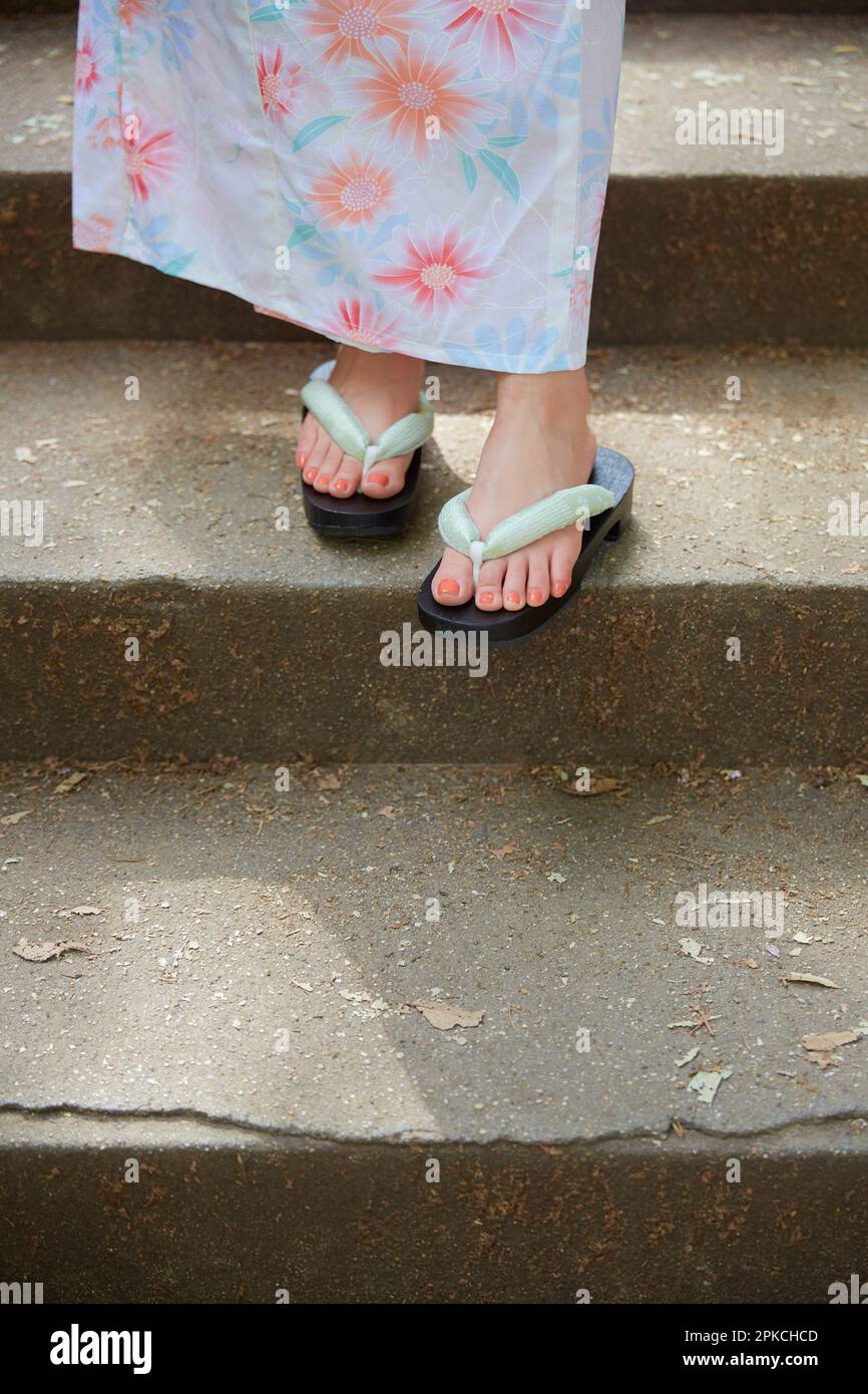 Woman's feet going down the stairs in yukata Stock Photo - Alamy