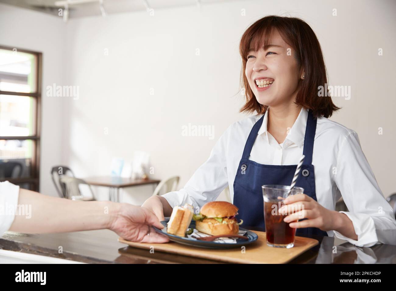 Café waitress receiving food Stock Photo - Alamy