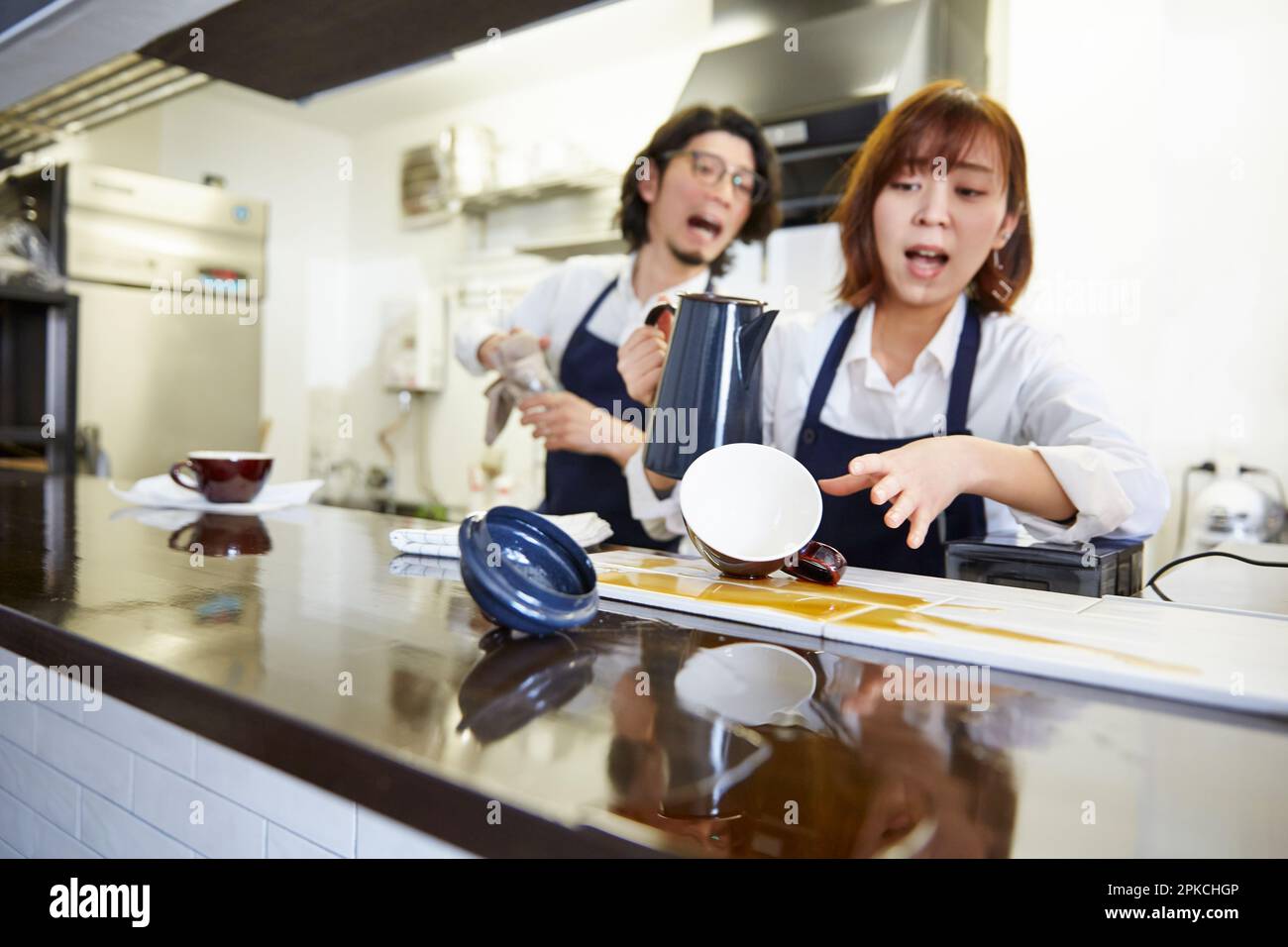 A female waitress spills coffee and a male waiter panics Stock Photo ...