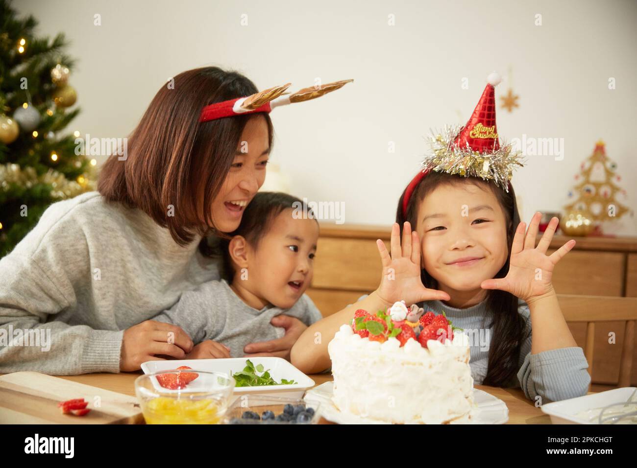 A parent and child celebrating the completion of their Christmas cake ...