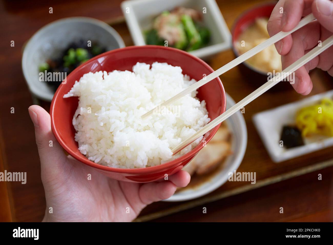 Hand of a man about to eat a set meal Stock Photo - Alamy
