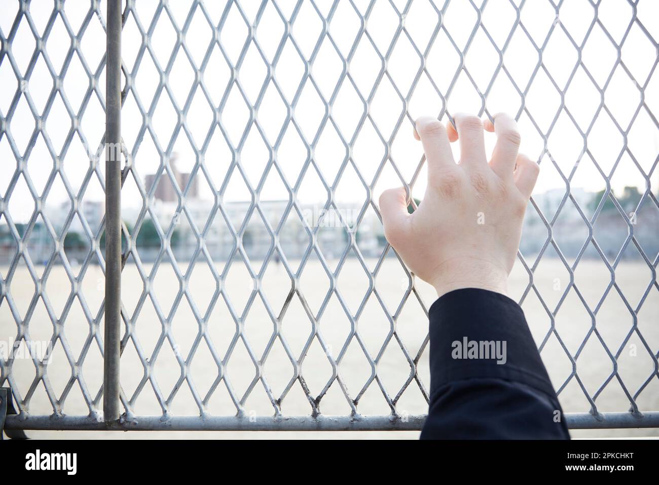 Man climb fence hi-res stock photography and images - Alamy