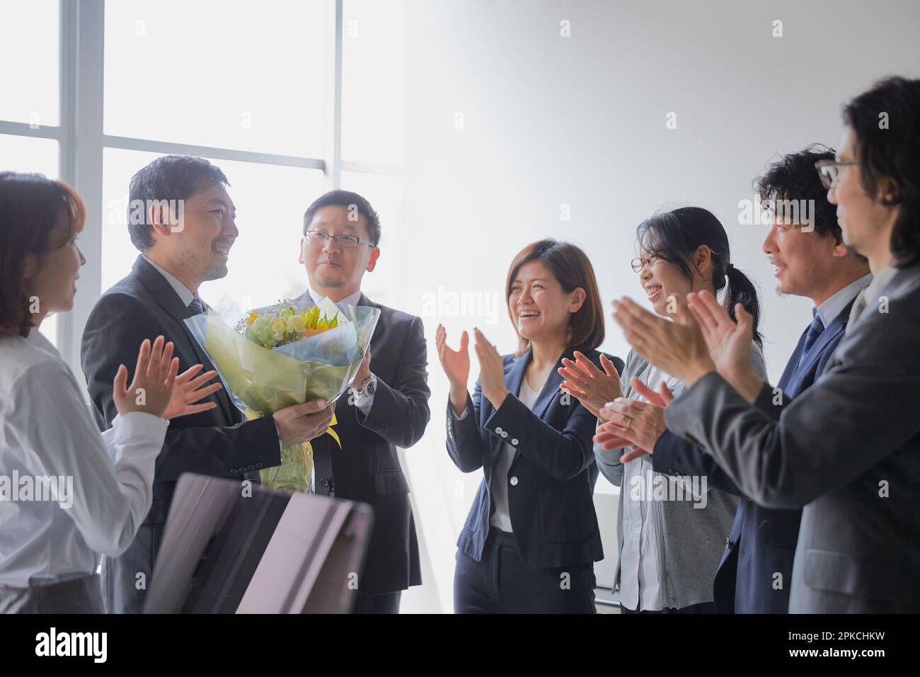 Employees congratulating their boss on his retirement Stock Photo - Alamy
