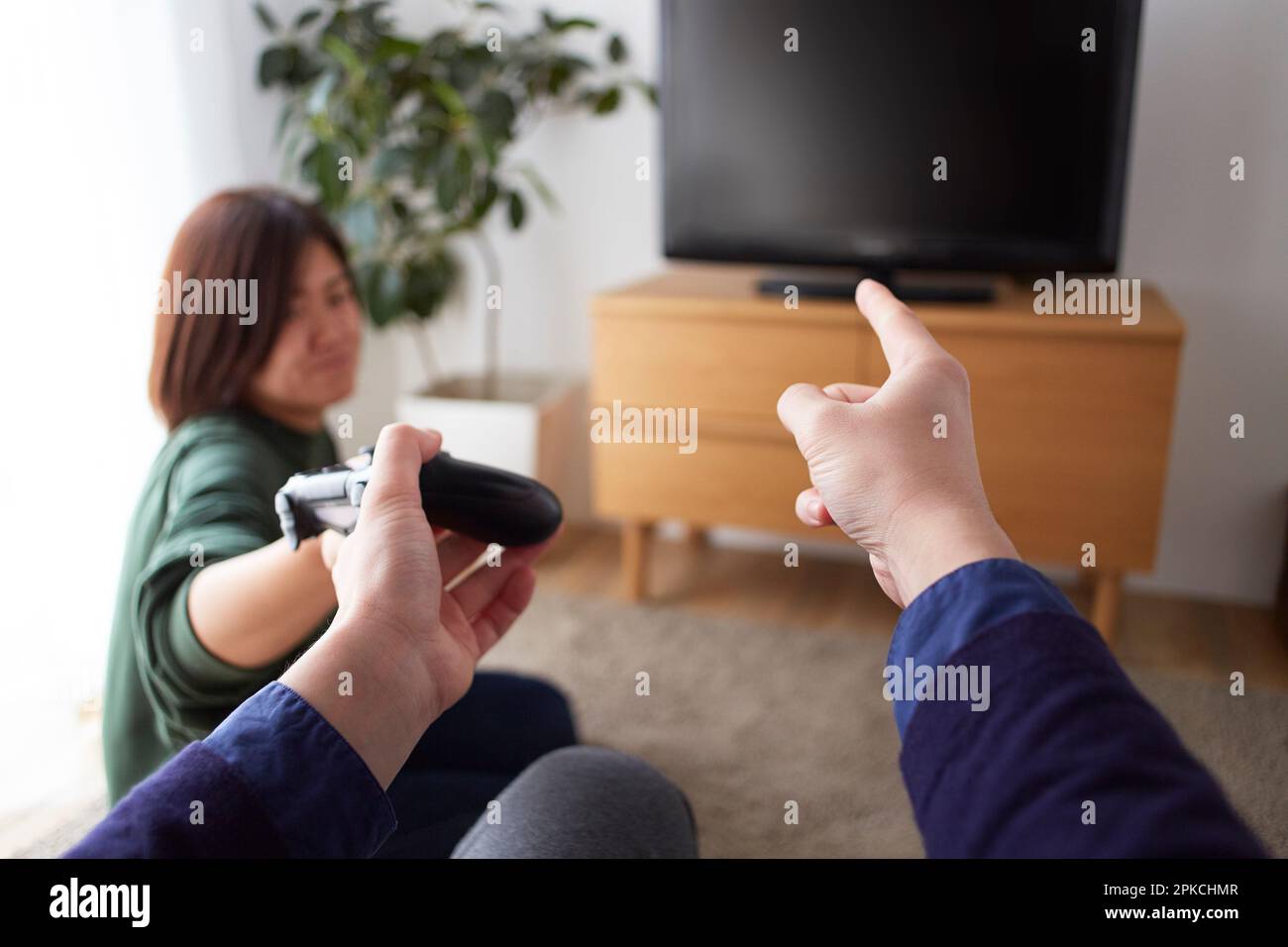 An angry man playing video games with his friends in the living room ...