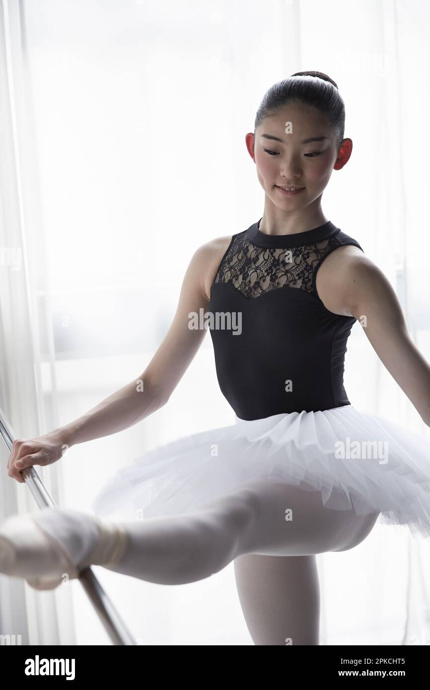 Ballerina with her legs over the bar Stock Photo - Alamy