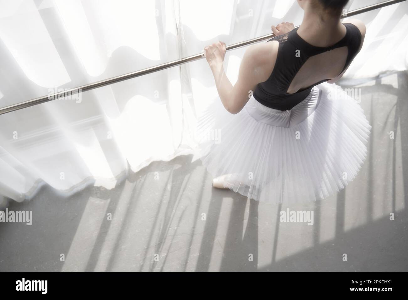 Ballerina holding a window bar Stock Photo - Alamy