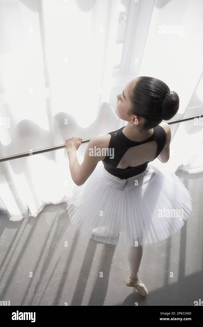 Ballerina holding the bar by the window Stock Photo - Alamy