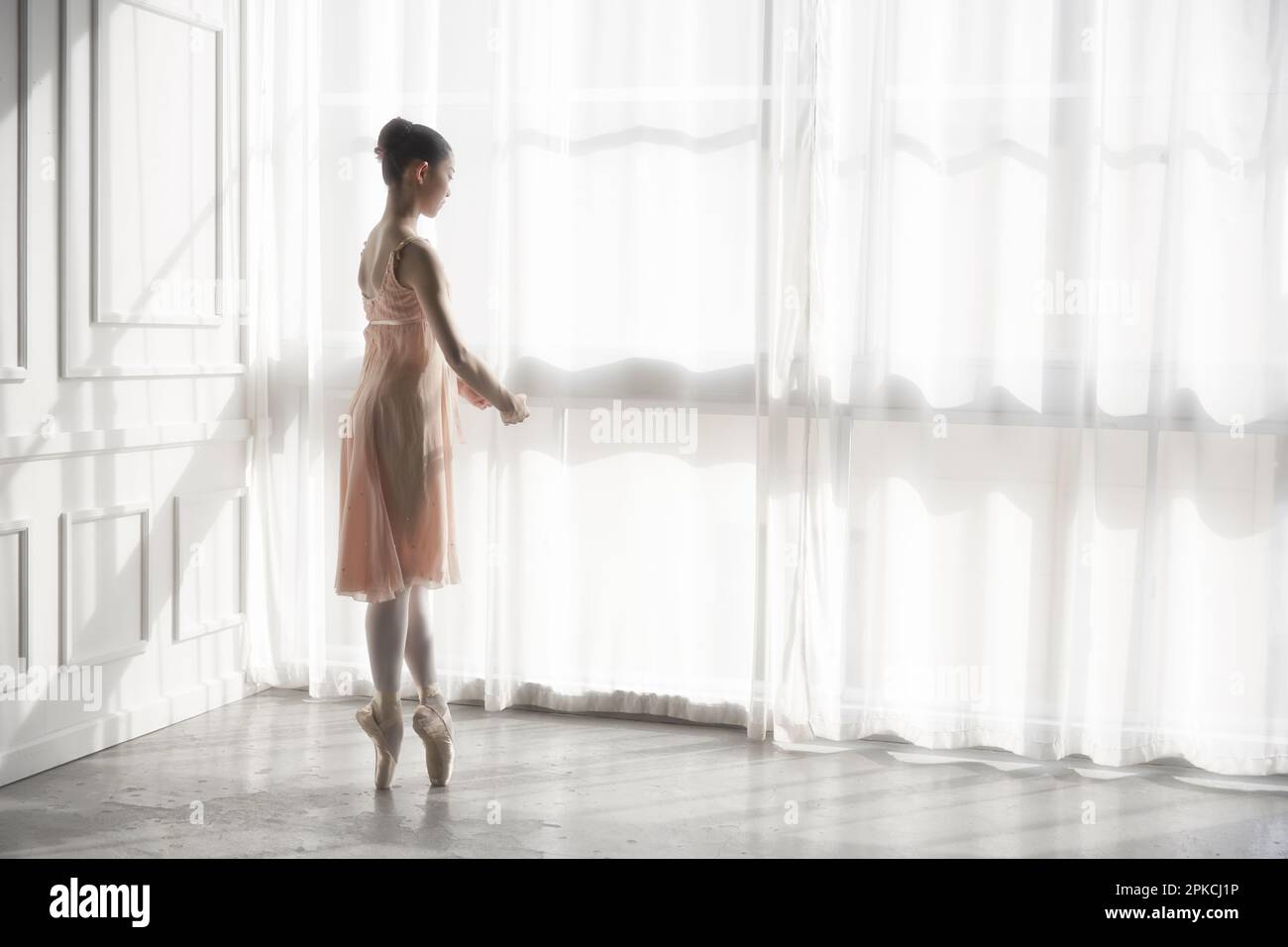 Ballerina standing by the window Stock Photo - Alamy