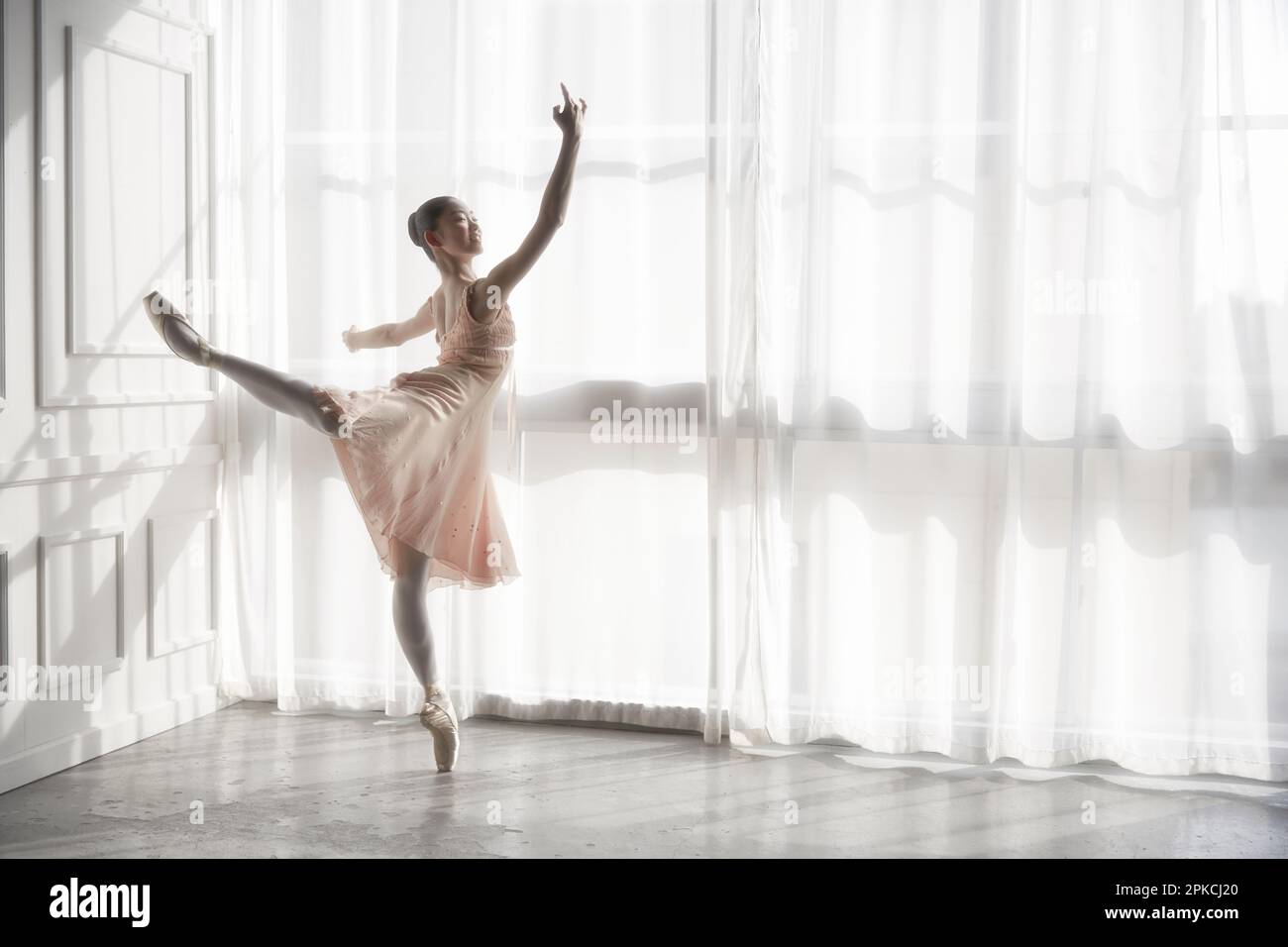 Ballerina standing by the window Stock Photo - Alamy