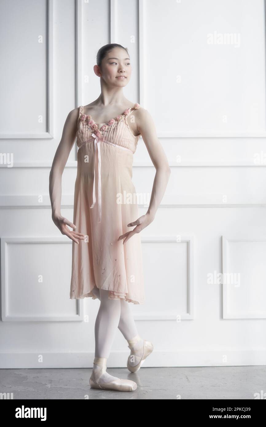 Ballerina standing in front of a wall Stock Photo - Alamy