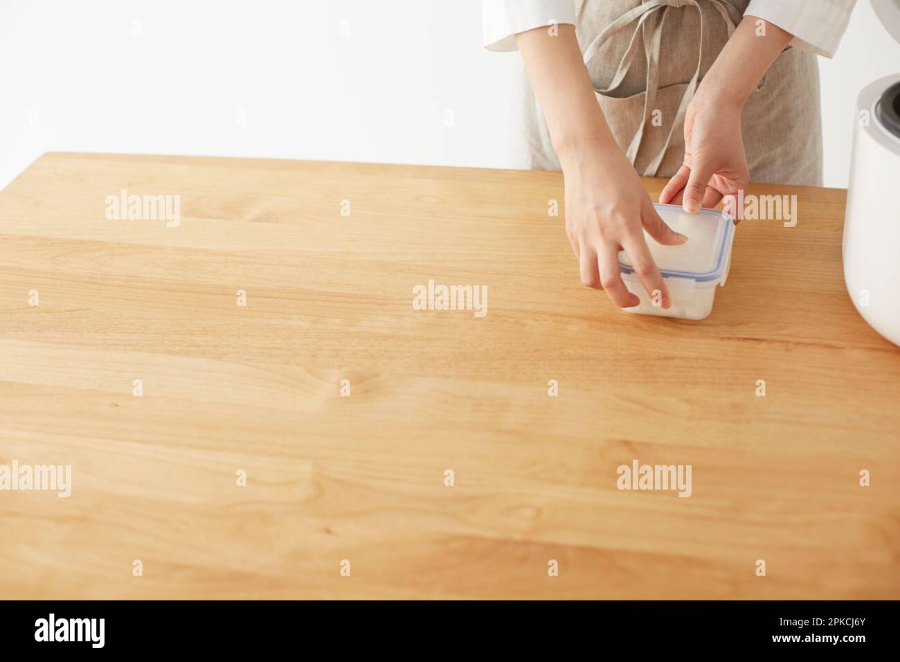 Woman occupying the lid of a Tupperware filled with white rice Stock ...