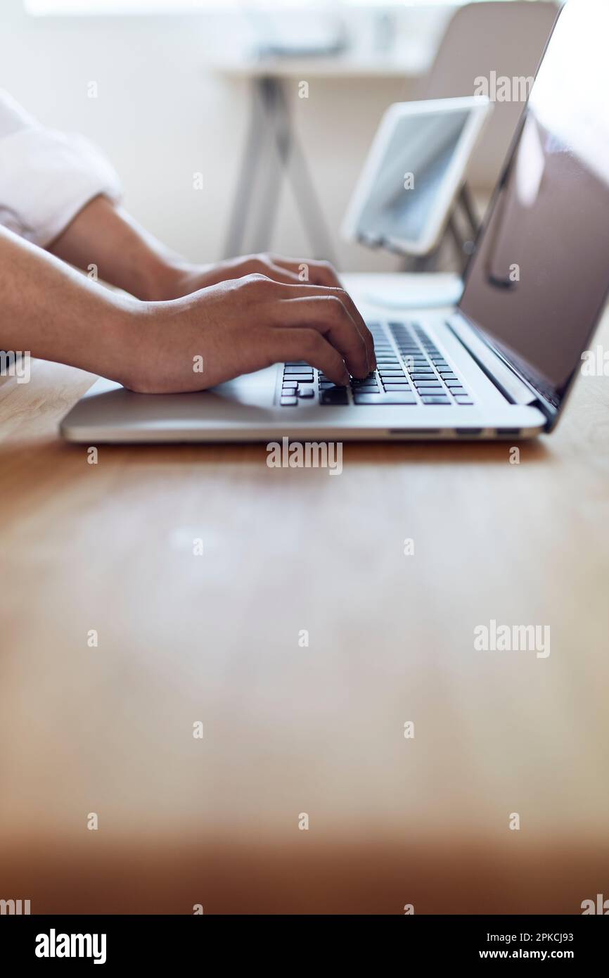A hand operating a computer and a tablet Stock Photo - Alamy