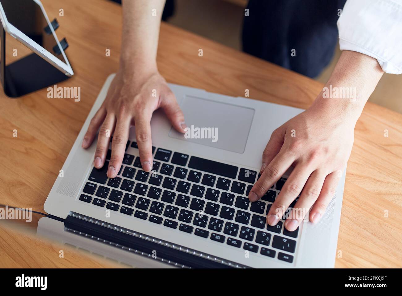 Hand and tablet operating a computer Stock Photo - Alamy