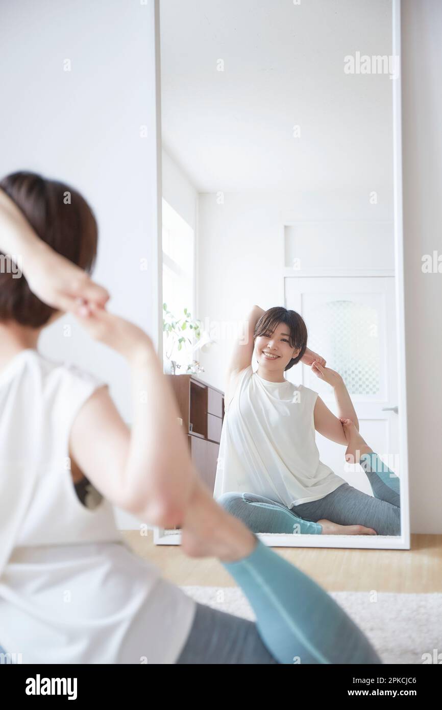 Woman stretching in a mirror Stock Photo - Alamy