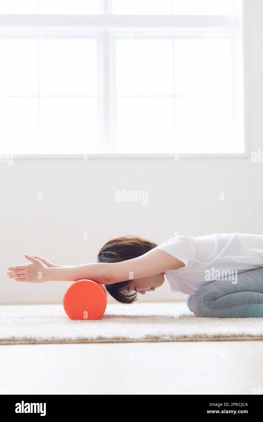 Woman on floor stretching arms hi-res stock photography and images - Alamy
