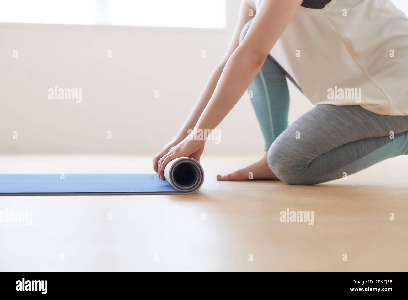 Rolling up yoga mat hi-res stock photography and images - Alamy