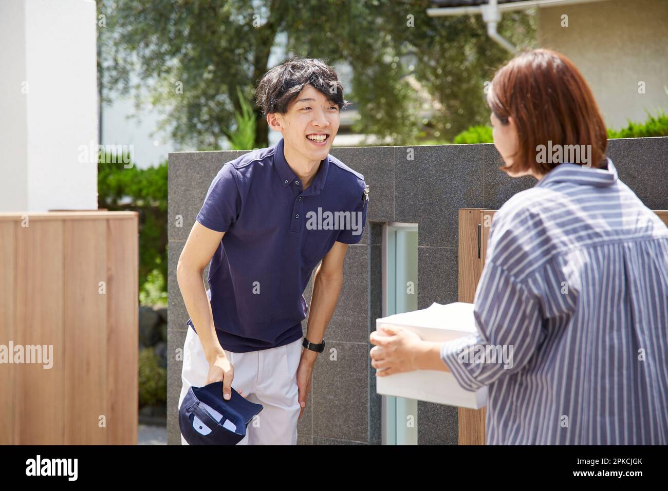 Delivery staff receiving and delivering packages Stock Photo - Alamy
