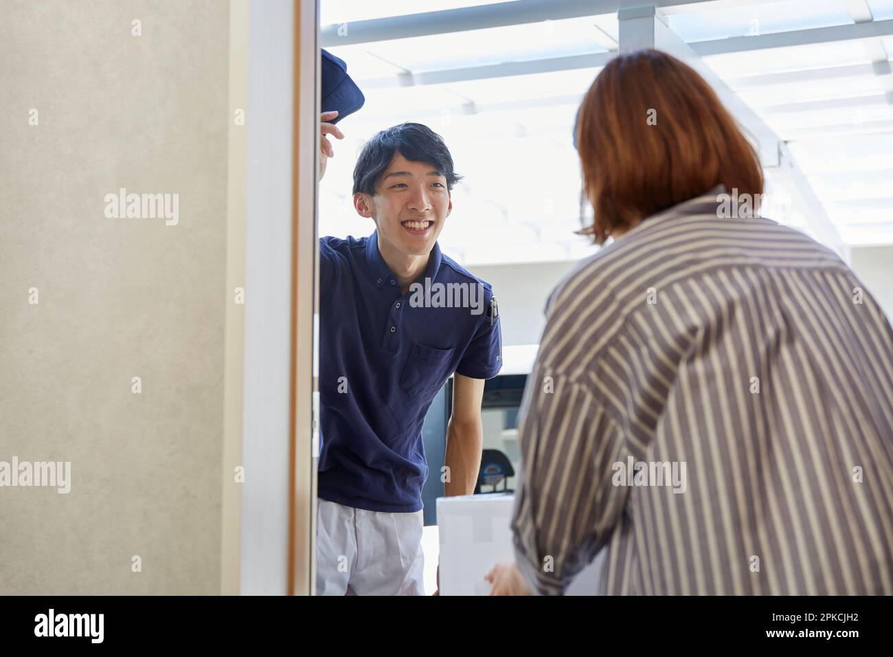 Delivery staff receiving and delivering packages Stock Photo - Alamy