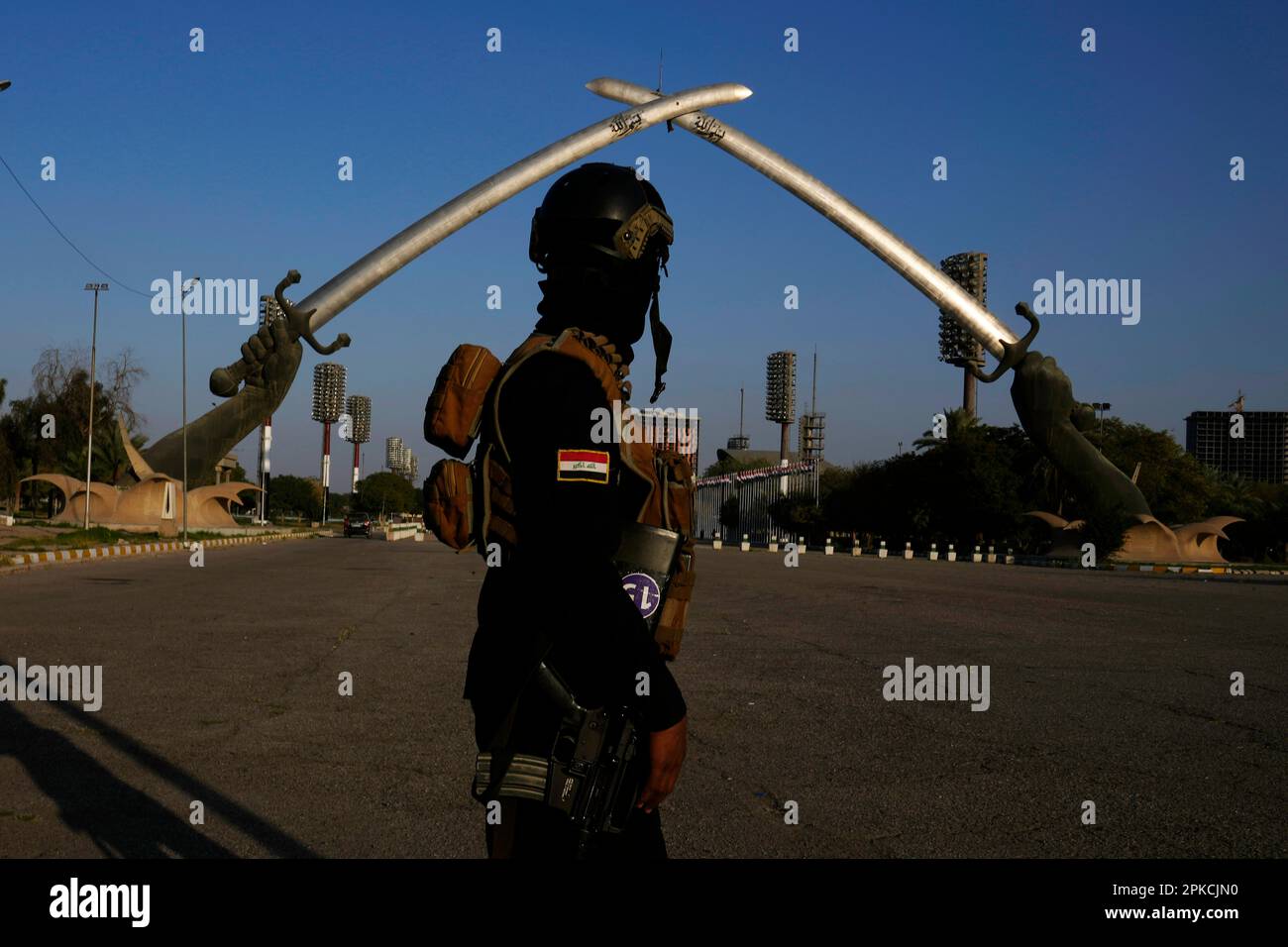 An Iraqi soldier passes under the Victory Arch monument built by former ...