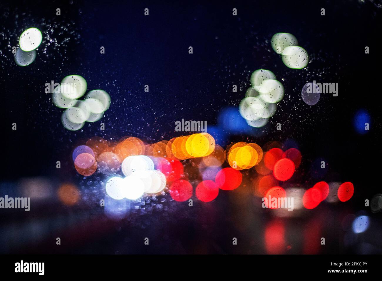abstract background of blurred multicolored light from headlights on a ...