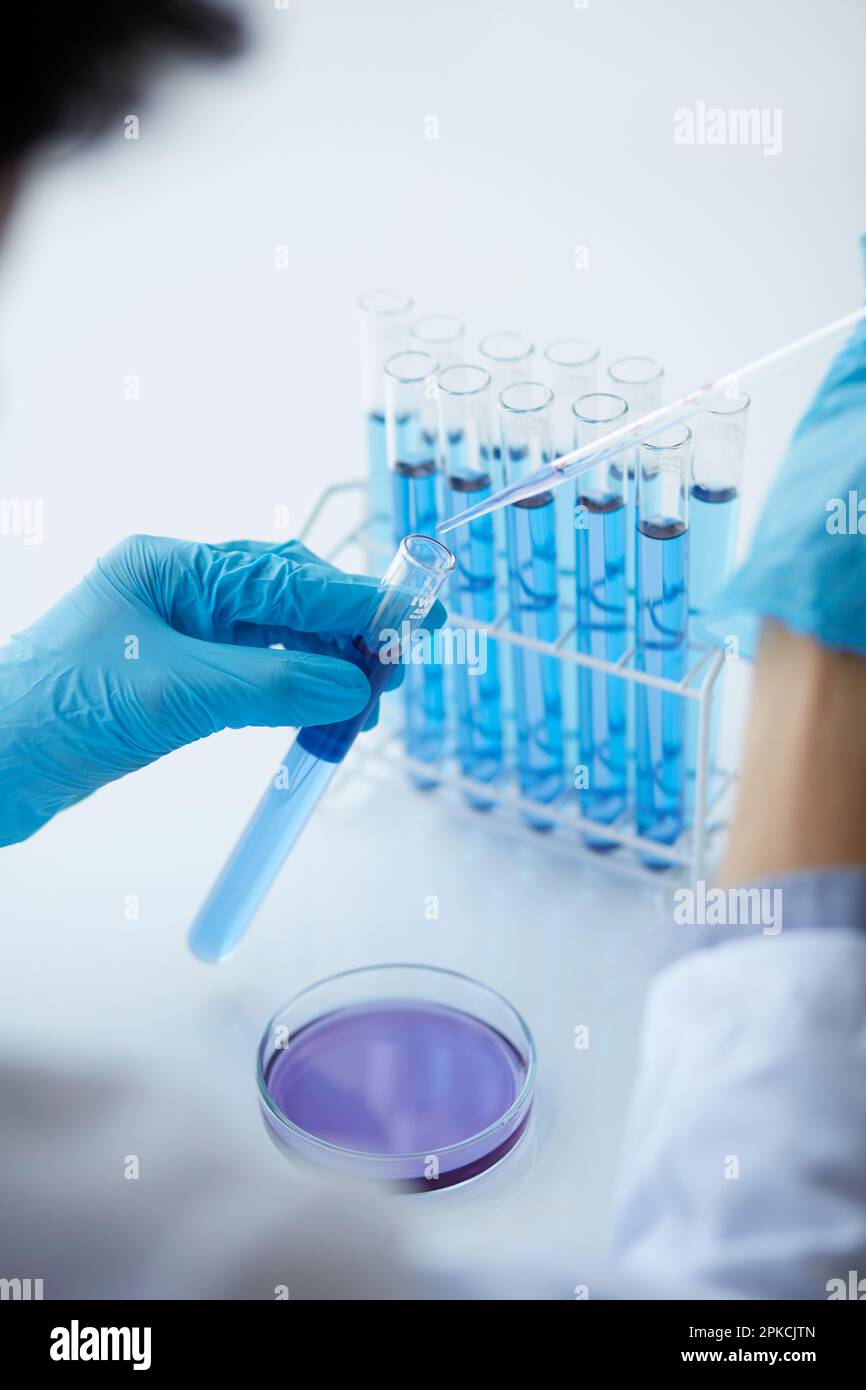 Man wearing white lab coat experimenting in a white space Stock Photo ...