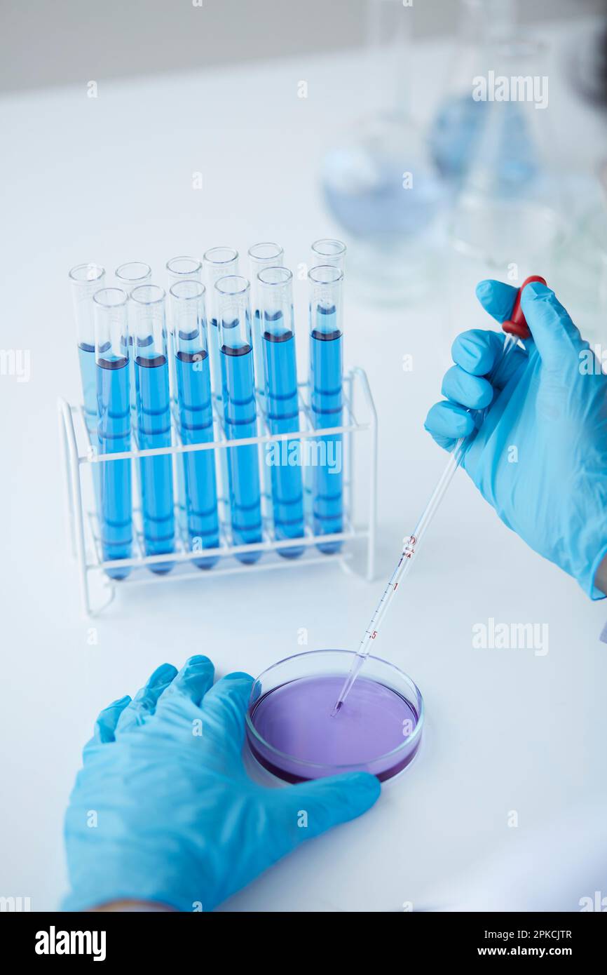 Man wearing white lab coat experimenting in a white space Stock Photo ...